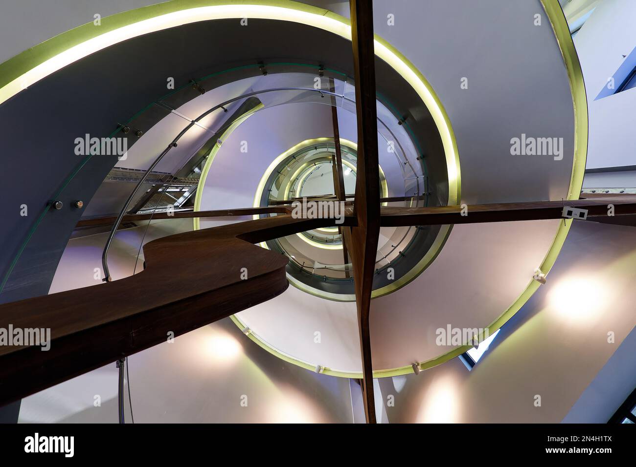 Spiral staircase seen from below and with artificial lighting ...