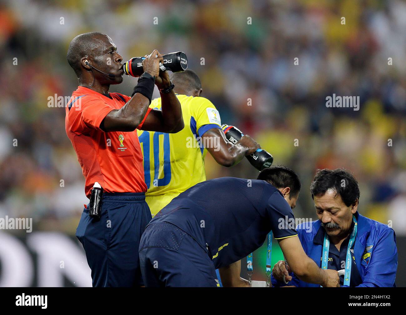 DISTRIBUTED FOR TCCC - An official tries to beat the heat by drinking ...