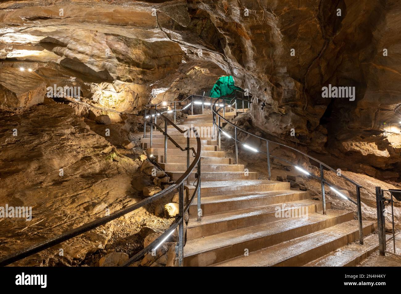 An illuminated staircase inside Goughs Cave in Cheddar in Somerset ...