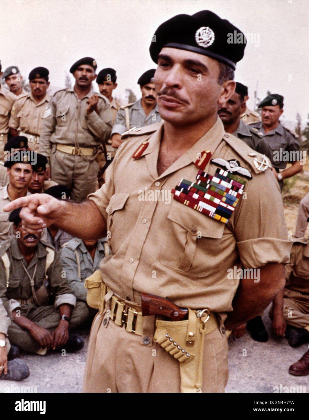 King Hussein of Jordan, dressed in full army uniform and showing his decorations is pictured ...