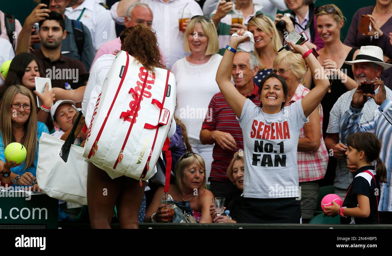 Serena Williams of U.S., signs autographs as a fan holds up her head ...