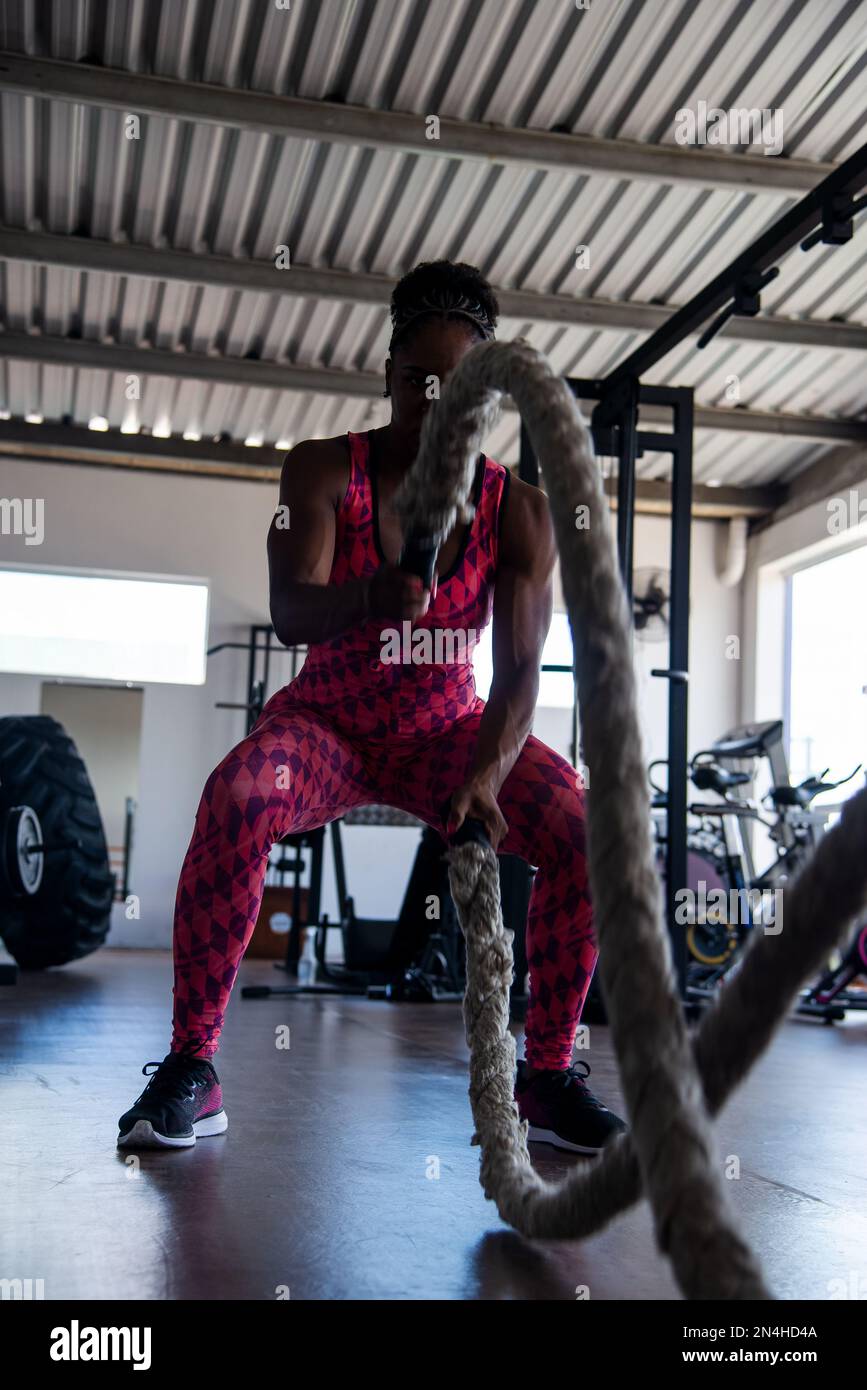 Woman doing training with naval rope. Abdominal strengthening and ...