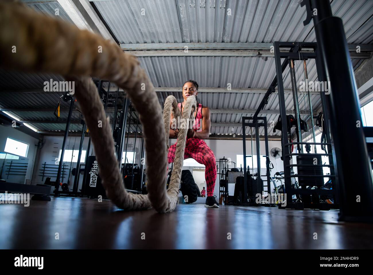Woman doing training with naval rope. Abdominal strengthening and ...