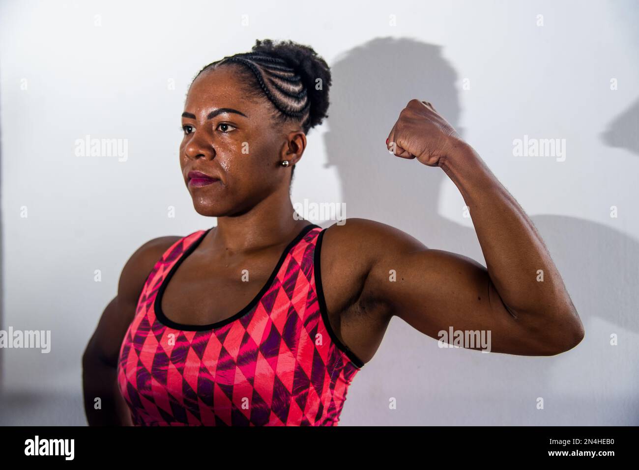 Beautiful woman showing upper muscles. isolated on white background ...