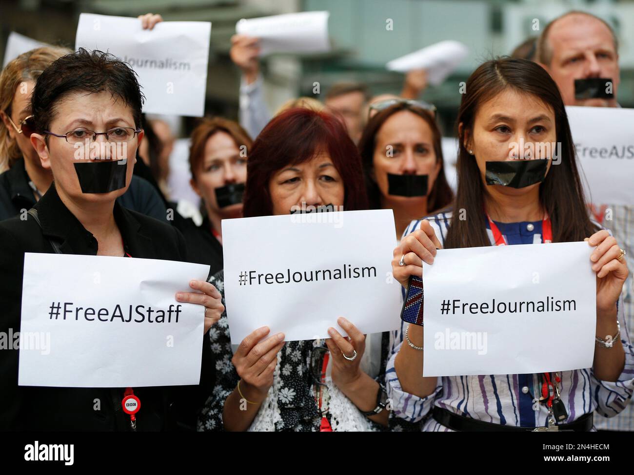 BBC journalists and staff, some with black tape over their mouths to ...
