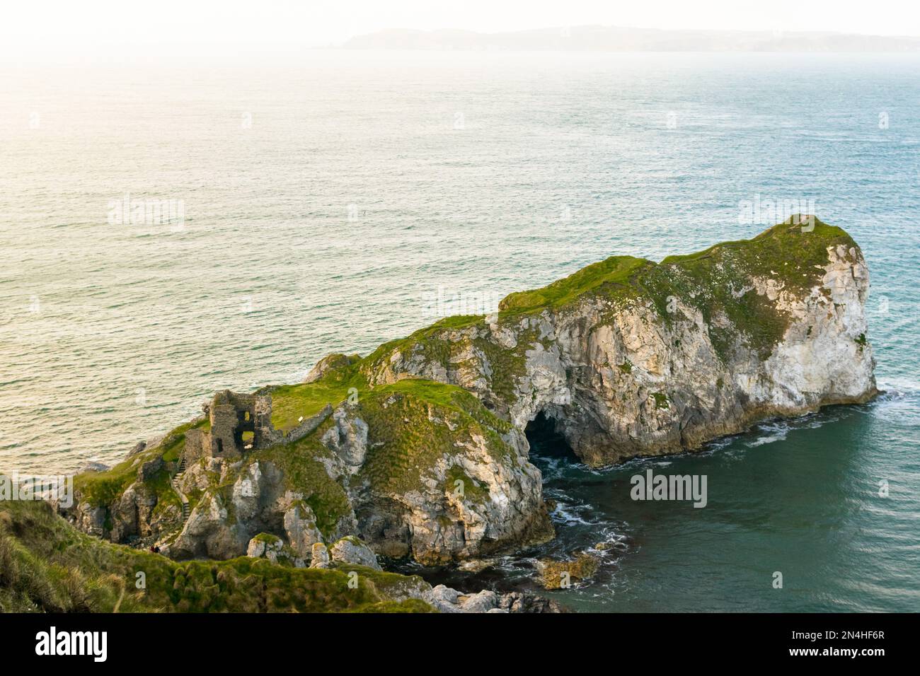 Kinbane castle ruins in northern ireland coast with calm blue sea in ...