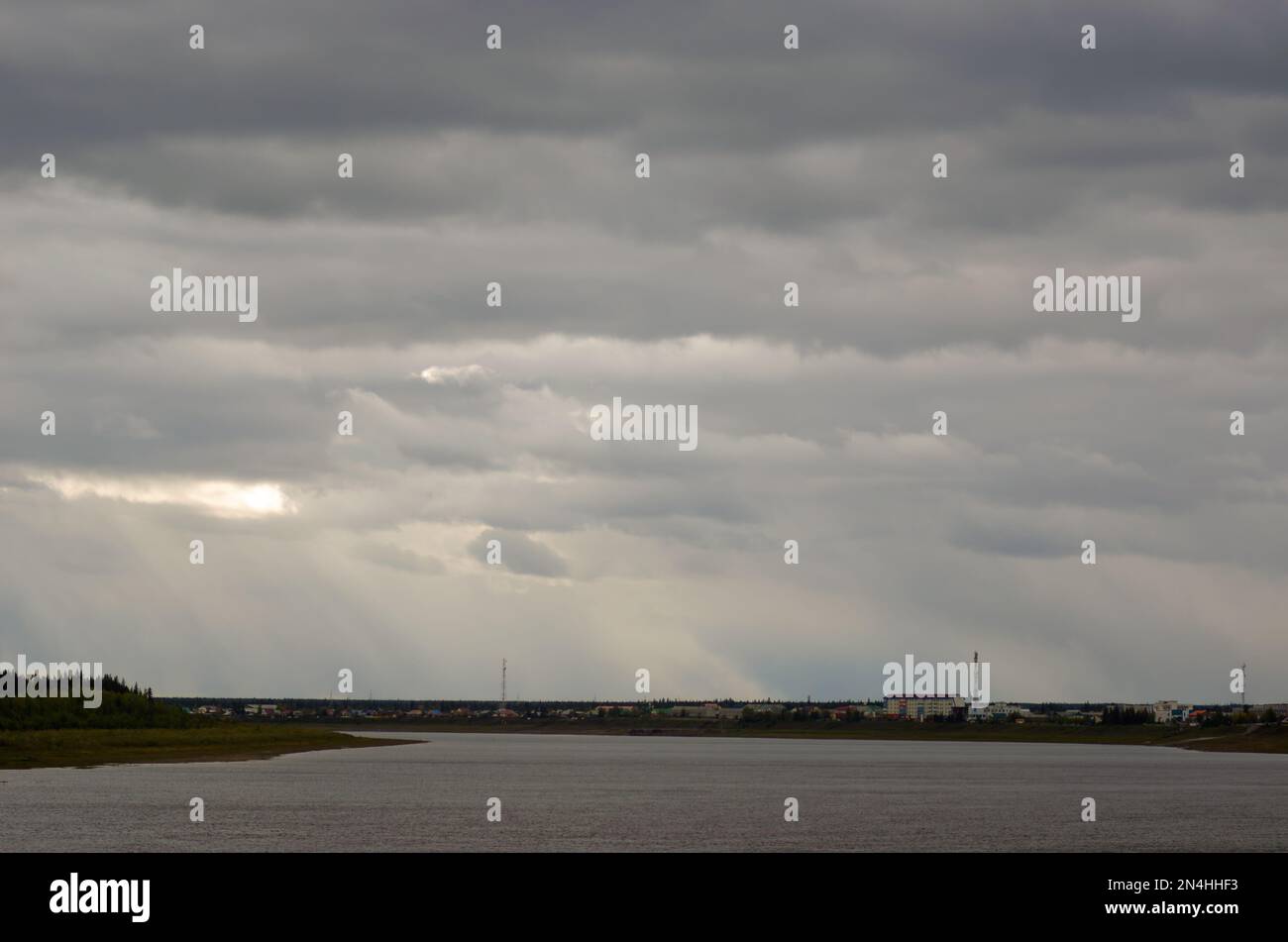 The sun's rays make their way through the clouds illuminating the ...