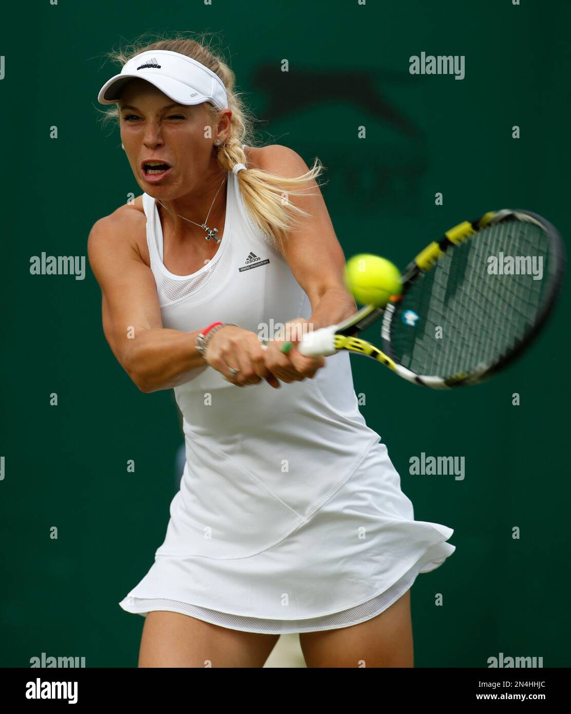 Caroline Wozniacki of Denmark plays a return to Shahar Peer of Israel ...