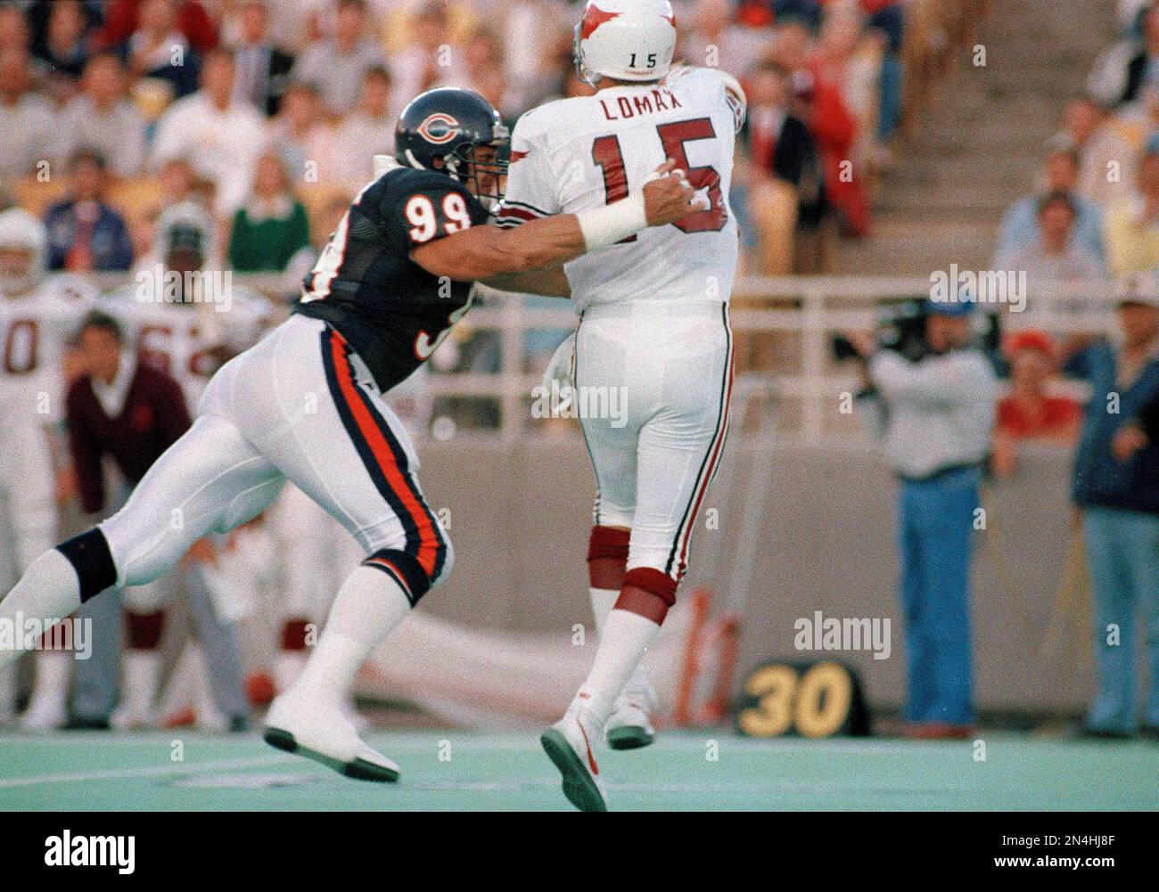 Chicago Bears Dan Hampton (99) grabs St. Louis Cardinals quarterback ...
