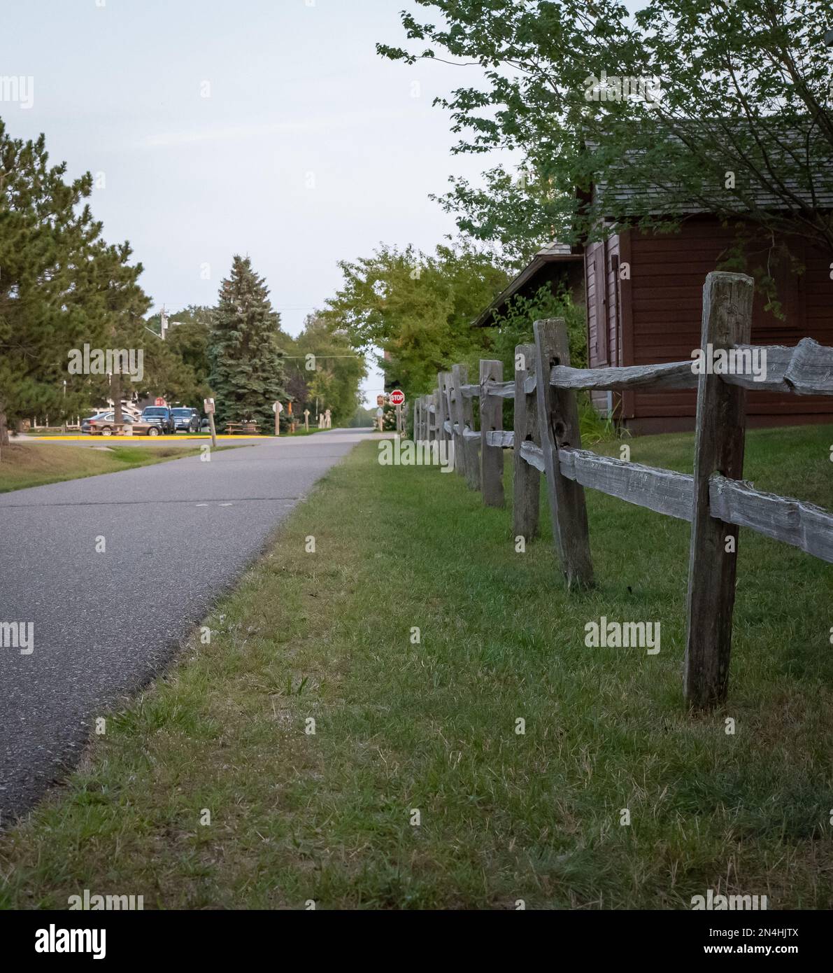 Split rail fence runs along the Paul Bunyan State Trail, an asphalt ...