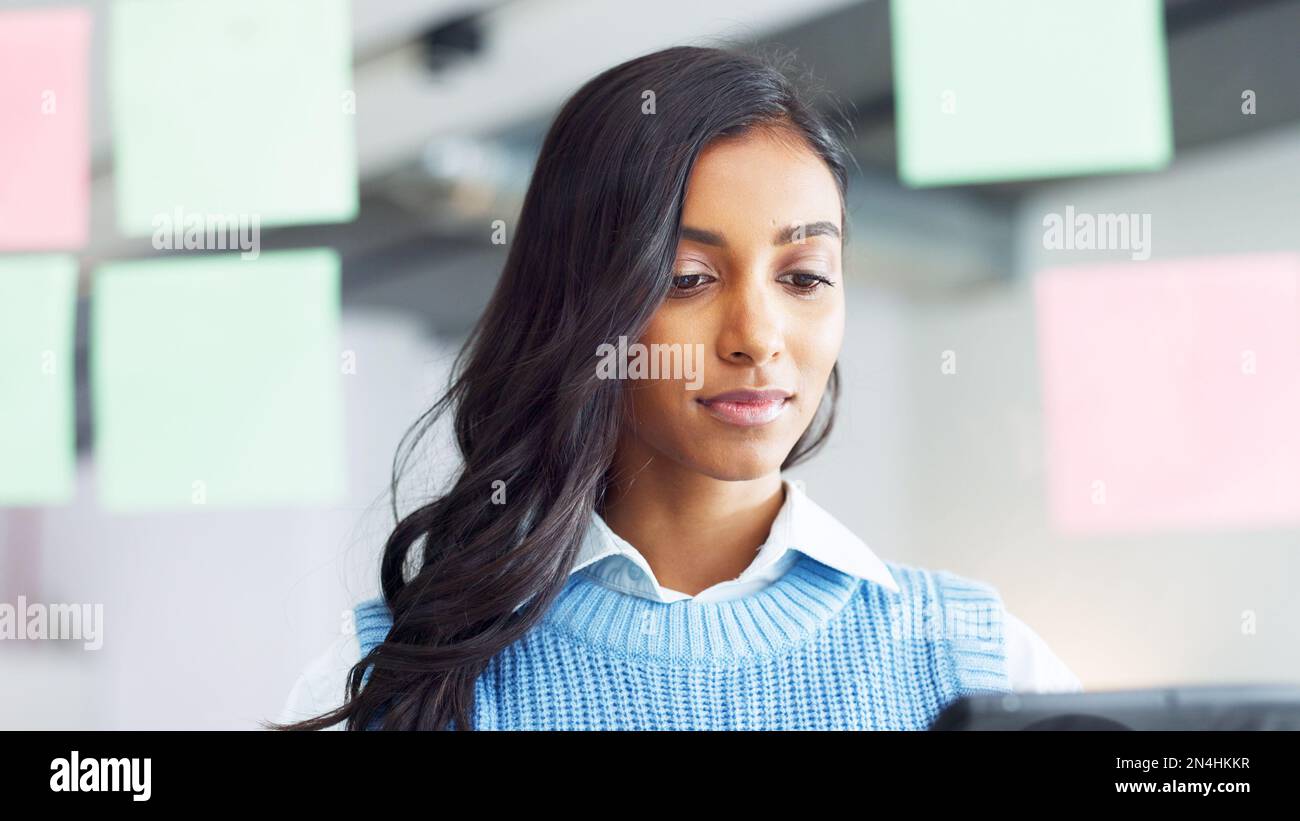 Focused young business woman thinking while brainstorming solutions for ...