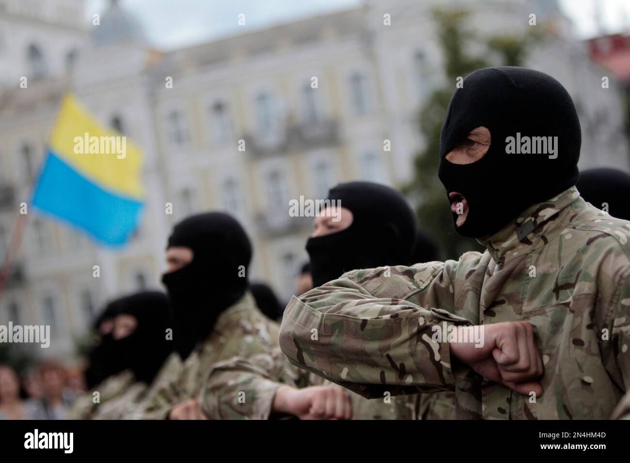 Volunteers take an oath of allegiance to Ukraine, before being sent to ...