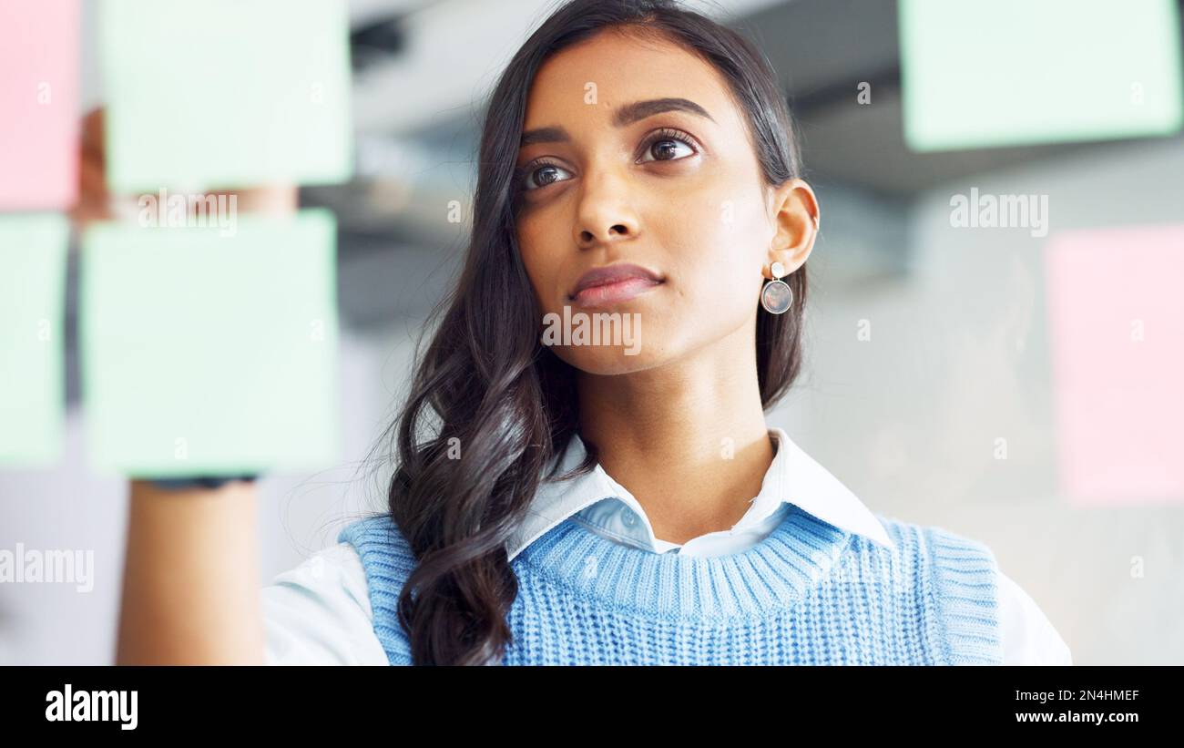 Focused young business woman thinking while brainstorming solutions for ...