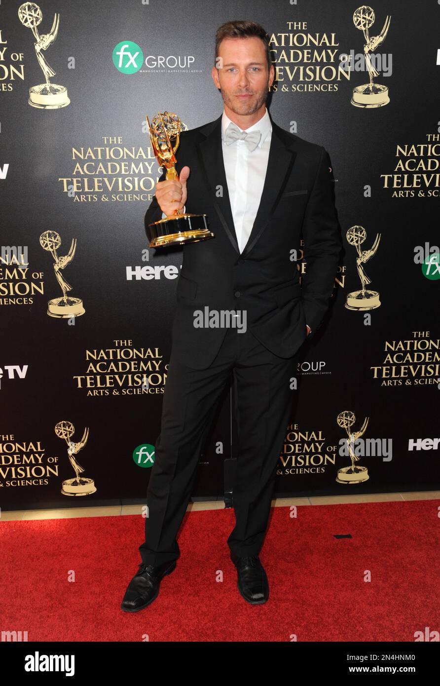Eric Martsolf poses in the press room with the award for outstanding ...
