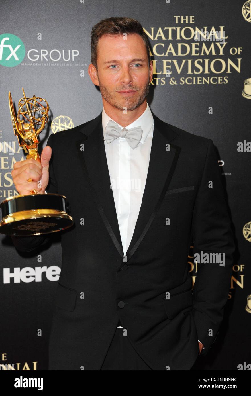 Eric Martsolf poses in the press room with the award for outstanding ...