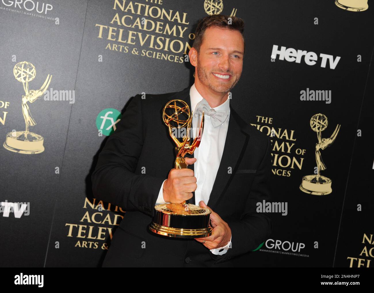Eric Martsolf poses in the press room with the award for outstanding ...