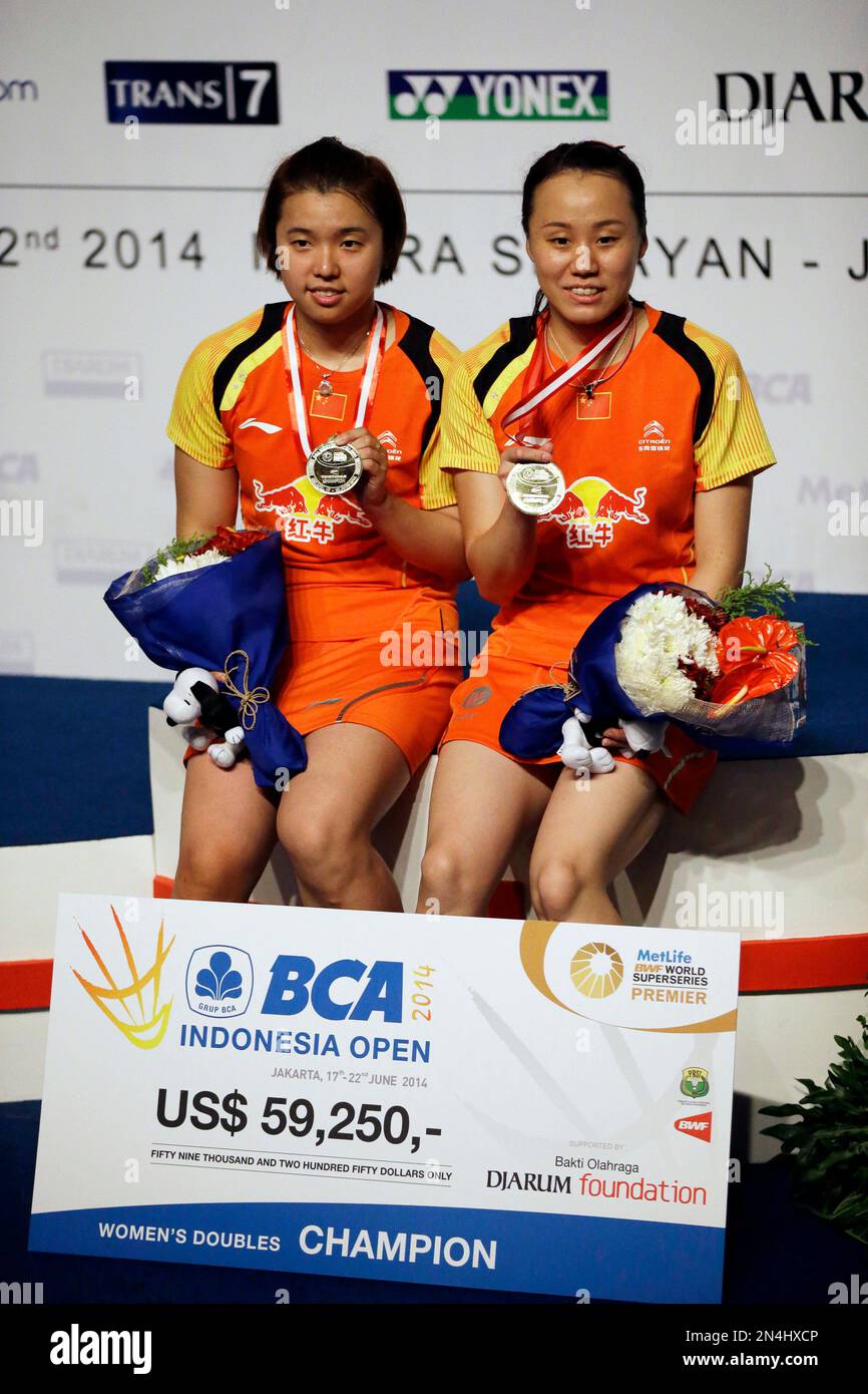 China's Tian Qing, left, and her team mate Zhao Yunlei pose with their medals after winning the ...