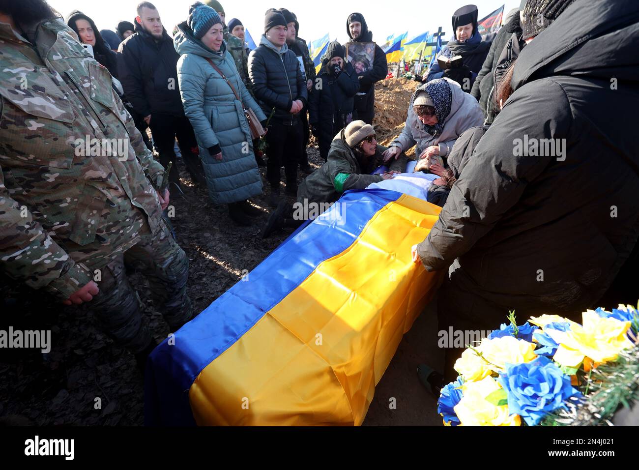 KHARKIV, UKRAINE - FEBRUARY 8, 2023 - Women mourn by the body of late ...
