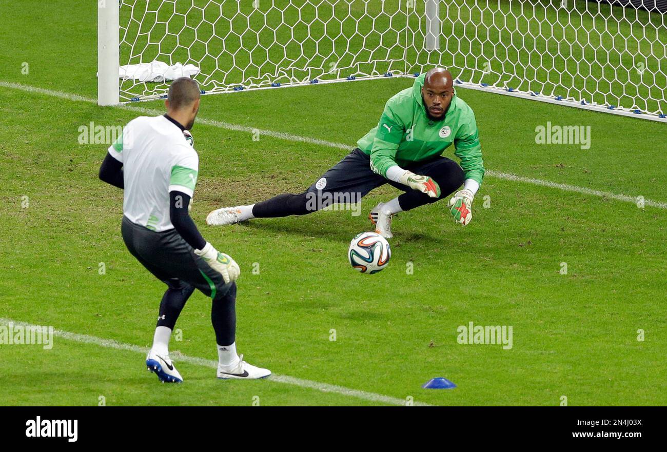 Algeria’s goalkeeper Rais Mbolhi, right, tries to catch a ball during ...