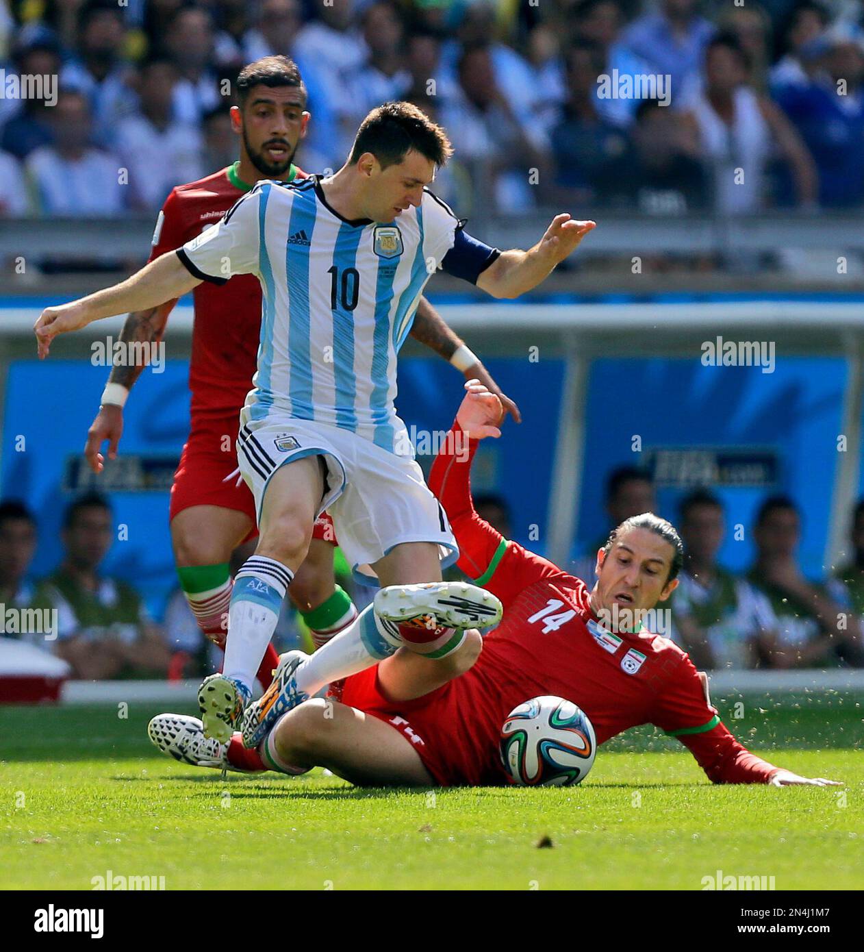 Argentina's Lionel Messi gets tangled with Iran's Andranik Teymourian ...