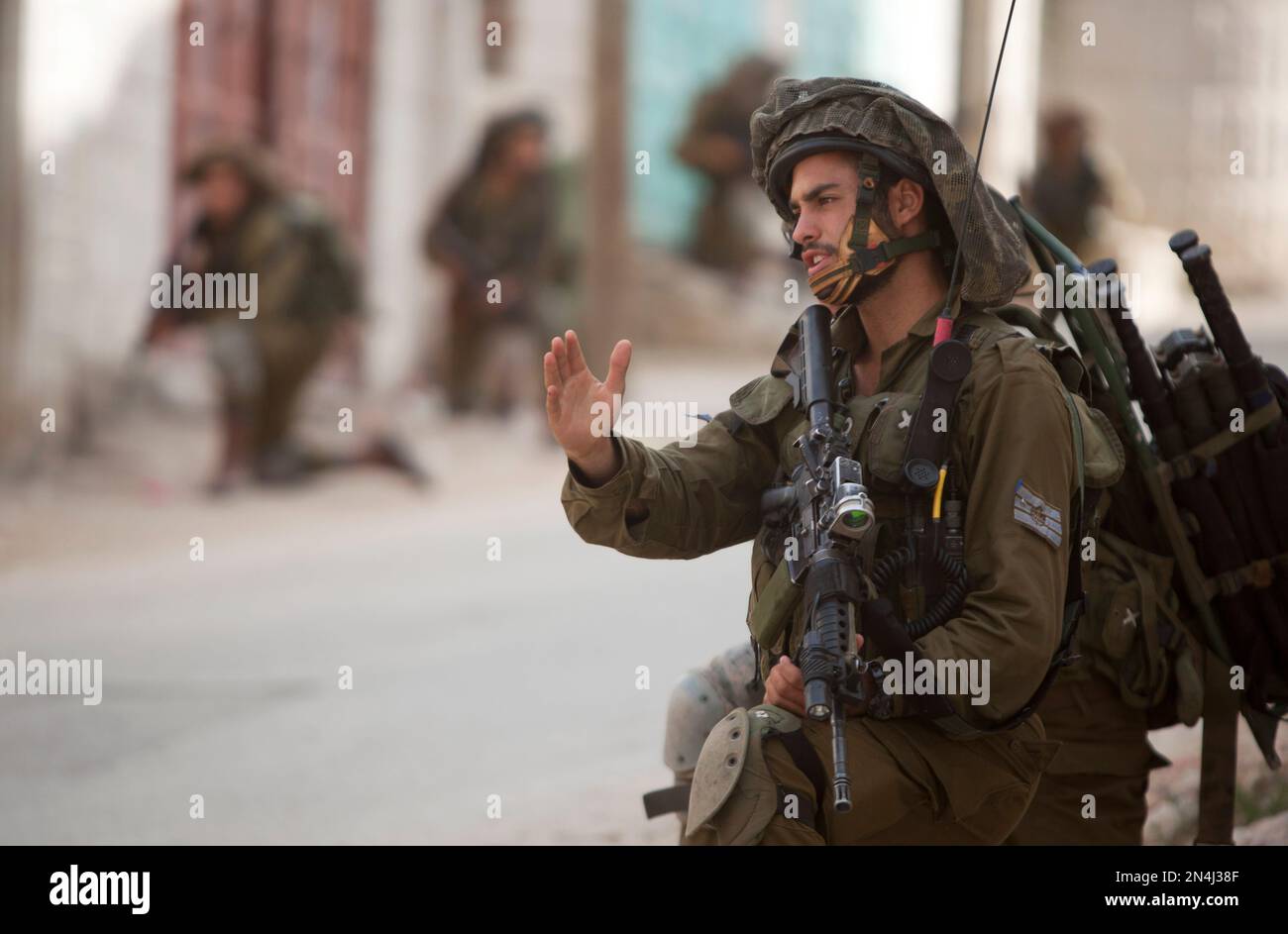 An Israeli soldier takes positions in search of three missing Israeli ...