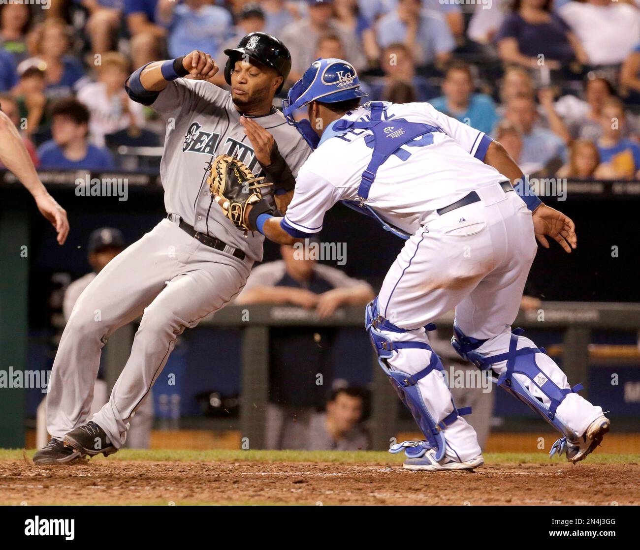 Seattle Mariners' Robinson Cano, left, is forced out at first by Kansas ...