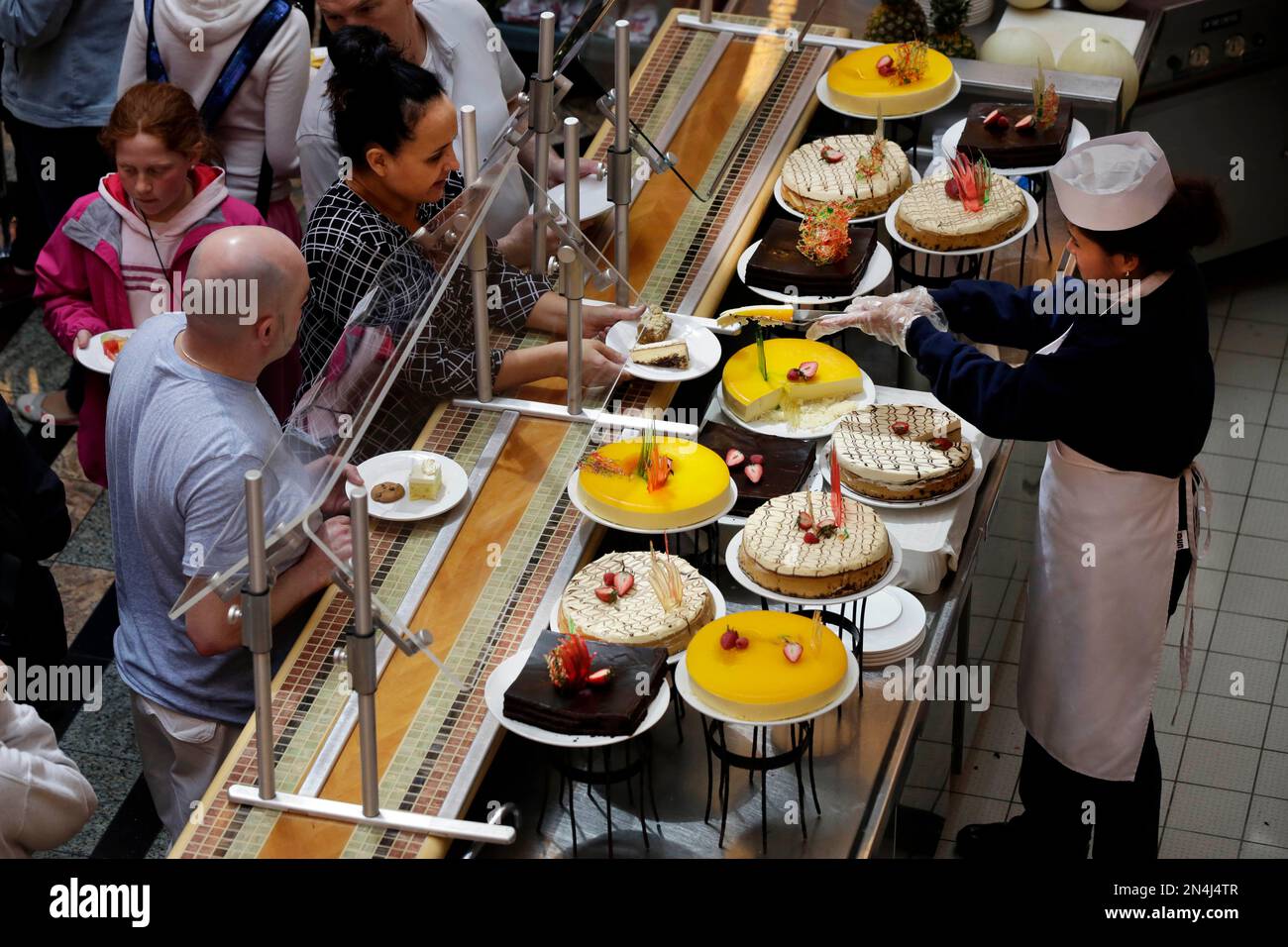 Passengers are served at the dessert bar of the Grand Buffet, aboard ...