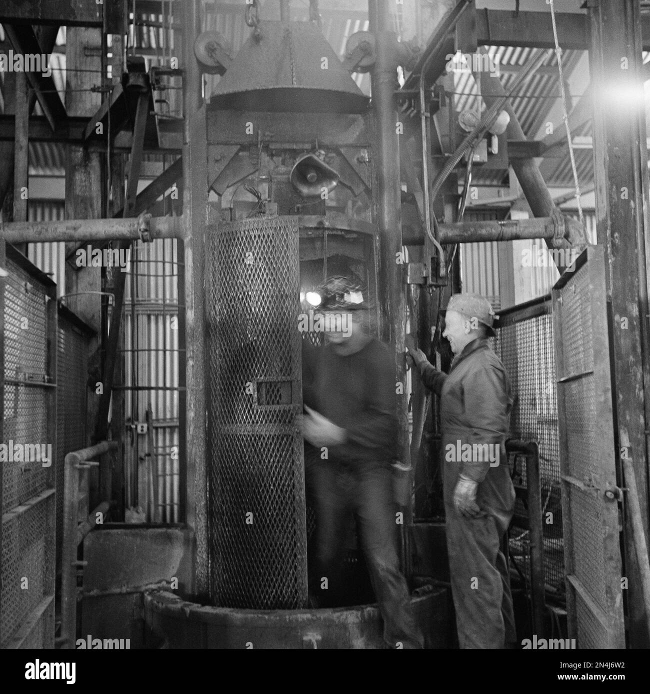 Unidentified miners board an elevator to go underground at Amchitka ...