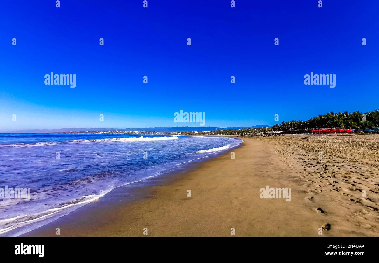 Sun beach sand people waves palms tourism and blue water in Zicatela ...