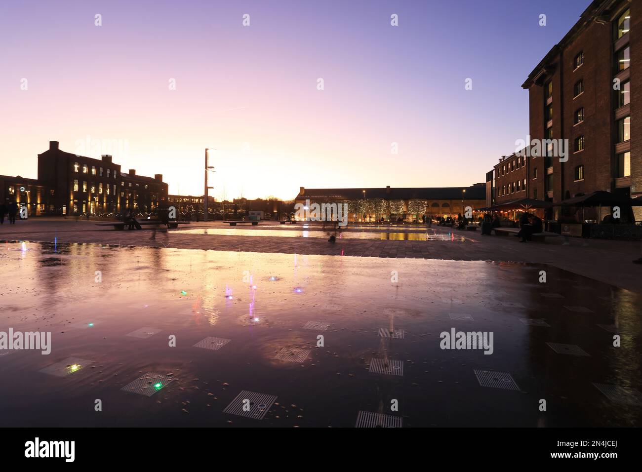 Coloured fountains in Granary Square at dusk in winter weather, at ...