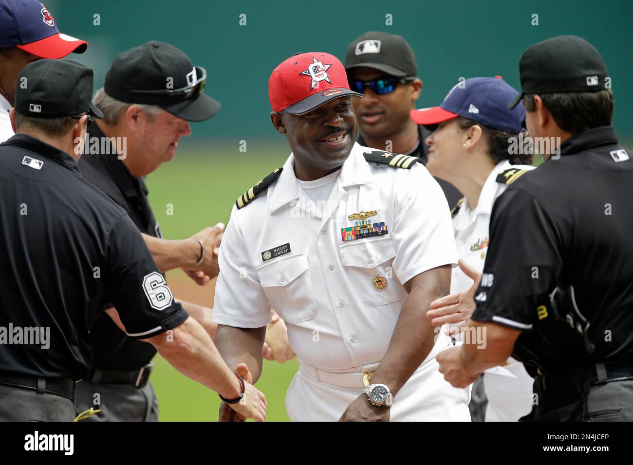 Lt. Cdr. Baylen Looney, center, and his wife, Cdr. Stormi Looney are ...