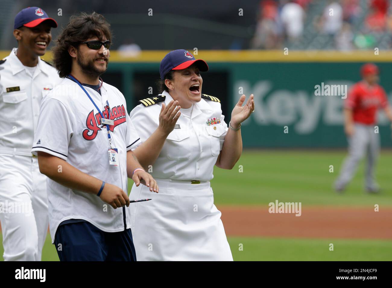 Navy Cdr. Stormi Looney reacts after throwing a ceremonial pitch before ...
