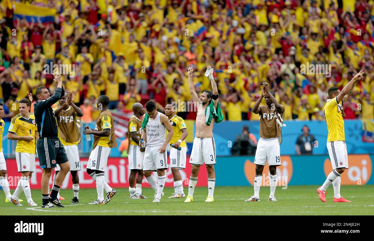 Colombian players celebrate after the group C World Cup soccer match ...