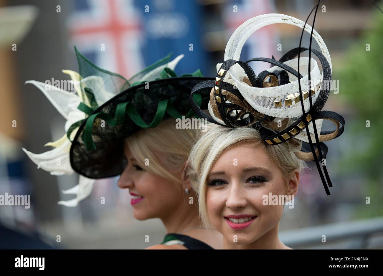 Sharon Teague, left and her daughter Ellie wear ornate hats as they ...