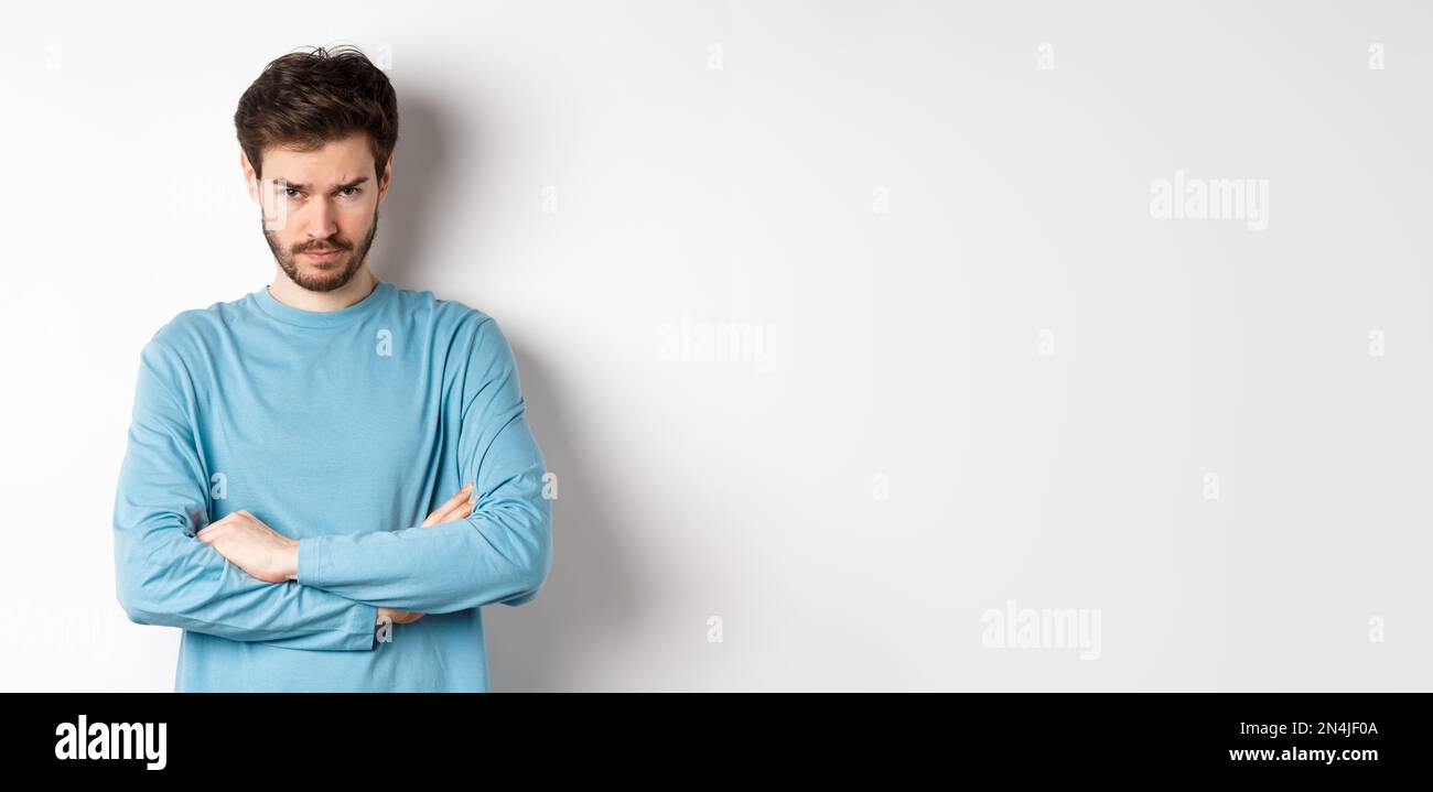 Image of offended and sad young man with beard, look from under ...