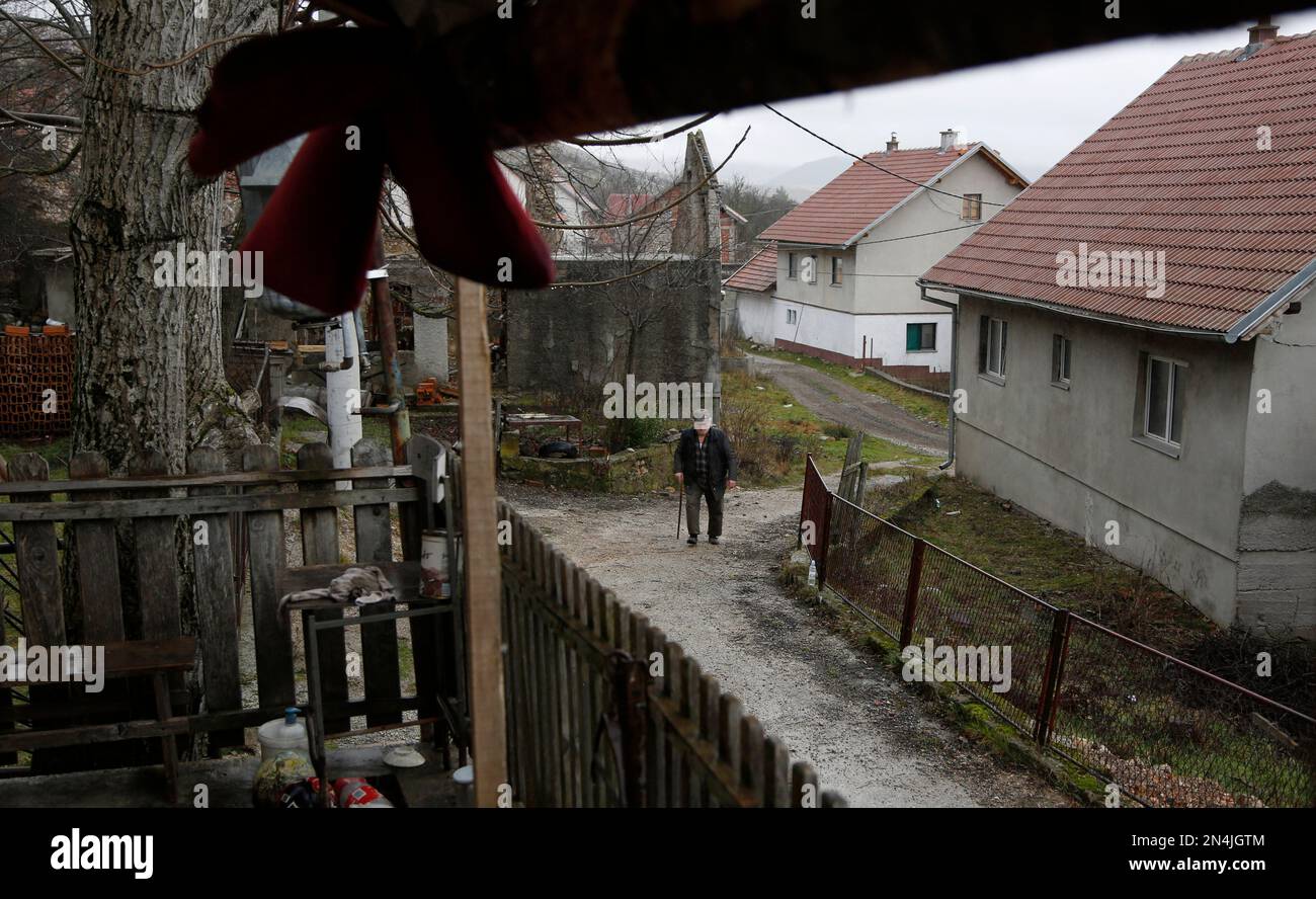 In this Feb. 5, 2014 photoa, a Bosnian man walks down an alley in the ...