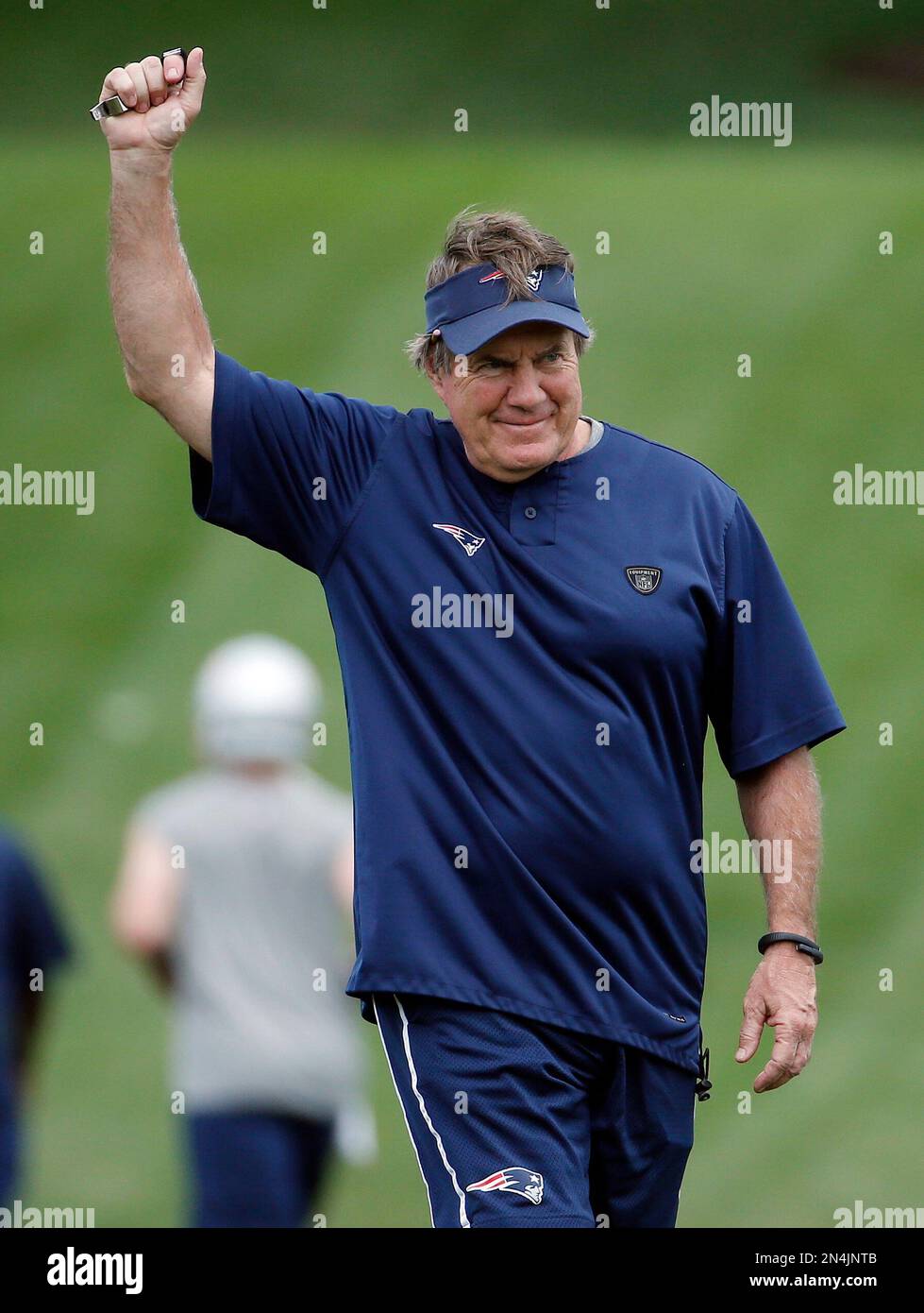 New England Patriots head coach Bill Belichick raises his arm during ...