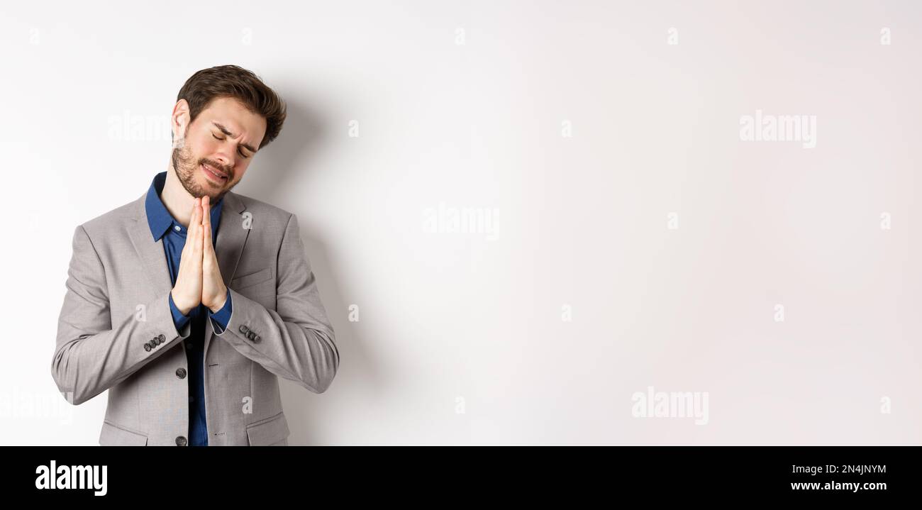 Pleading businessman begging for help, holding hands in pray and asking ...
