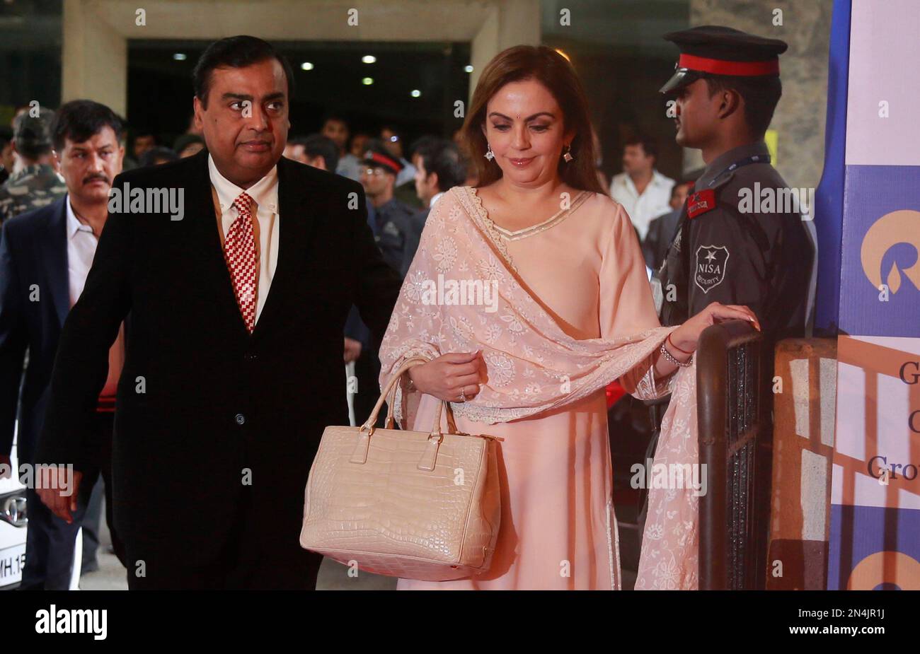 India's largest private sector company, Reliance Industries chairman Mukesh Ambani, left and his ...