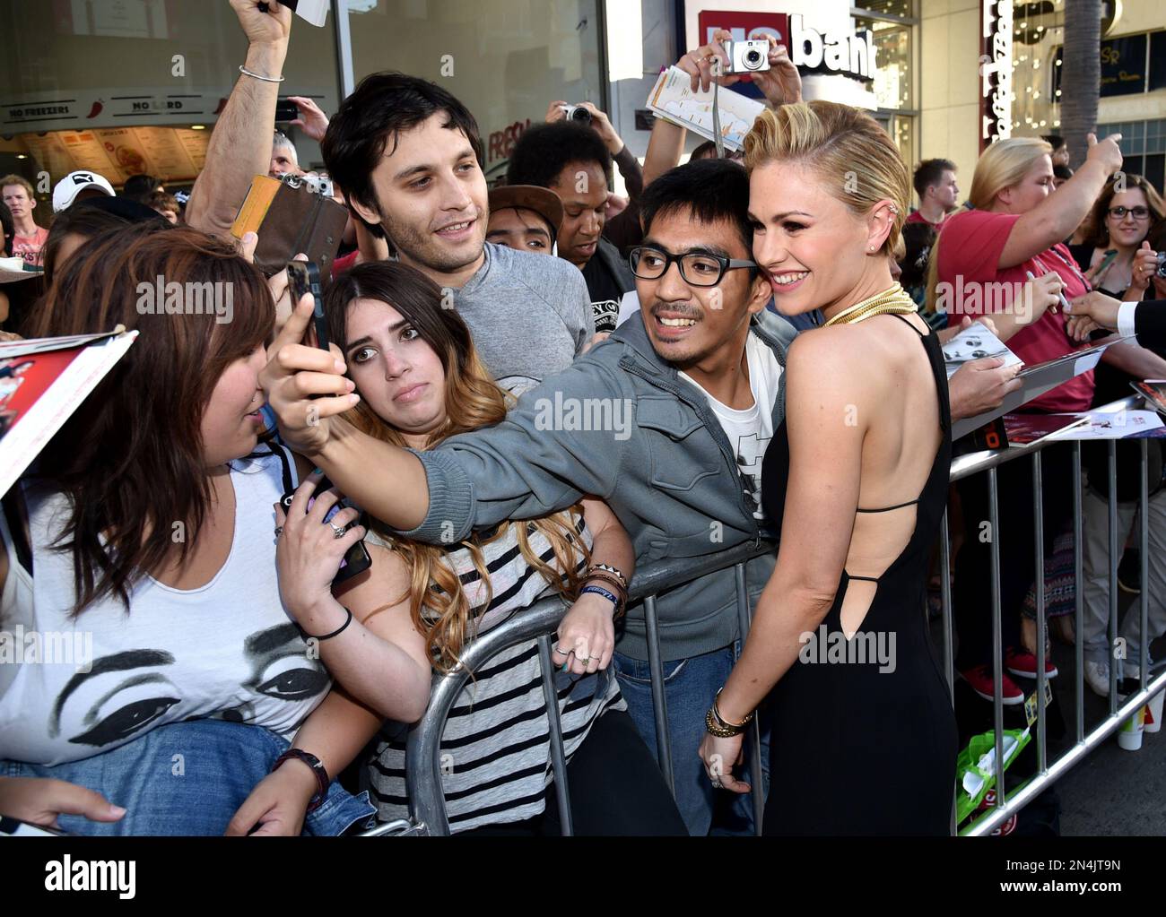 Anna Paquin, right, takes a photo with fans as she arrives at the Los ...