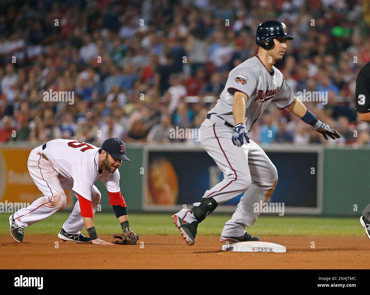 Minnesota Twins' Joe Mauer is safe at second with an RBI double as Boston Red Sox second baseman ...