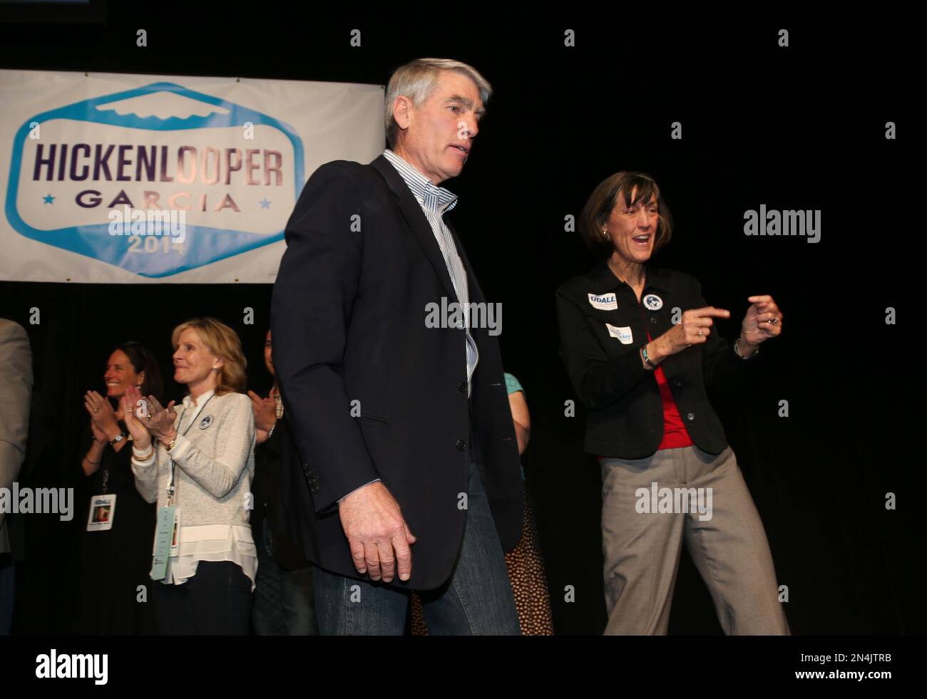 U.S. Sen. Mark Udall, front, D-Colo., heads off the stage with his wife ...