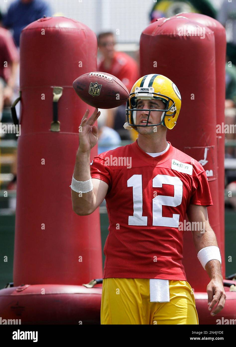 Green Bay Packers quarterback Aaron Rodgers spins a ball on his finger ...