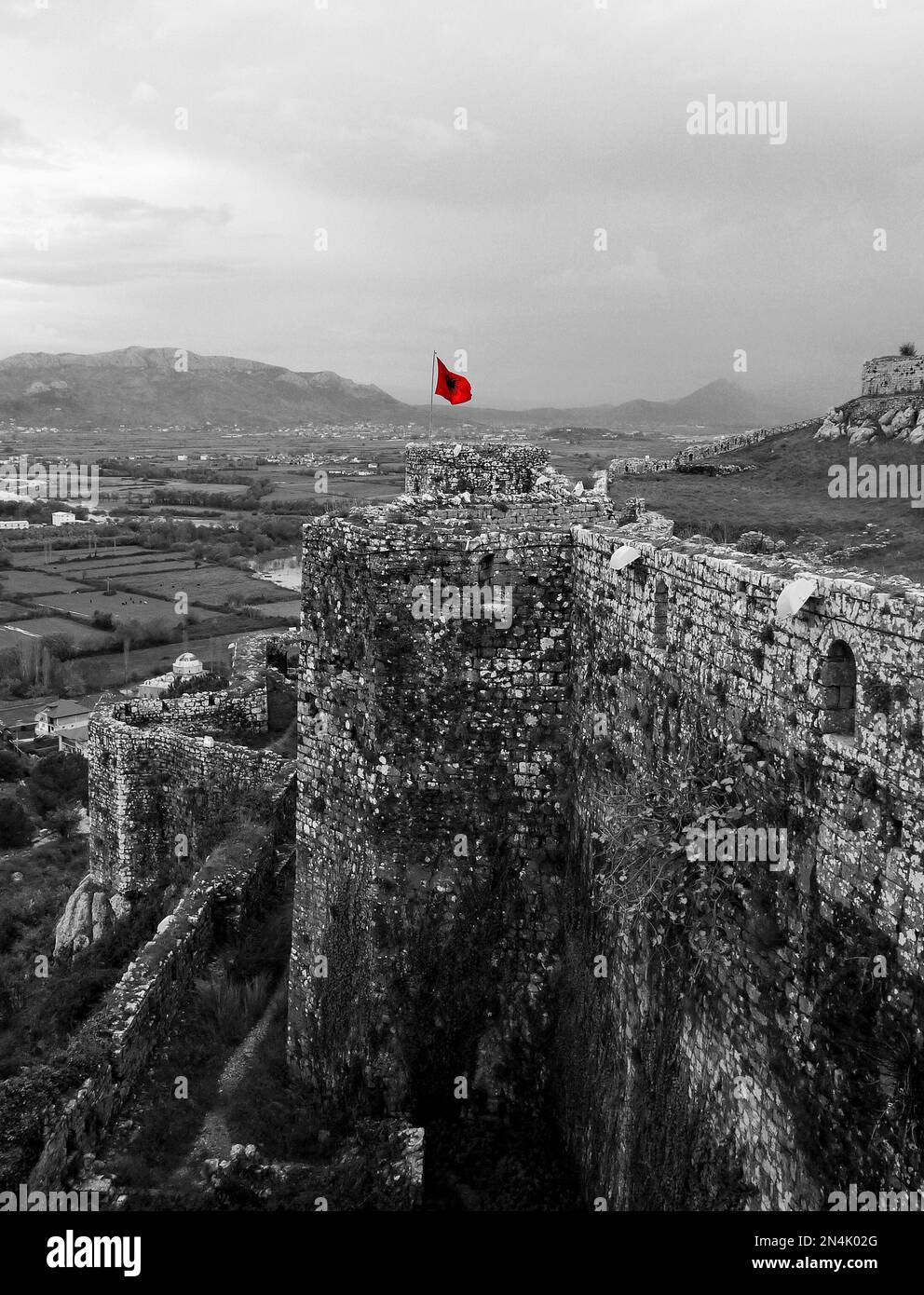 Walls of Rozafa Fortress with Albanian national flag in black and white ...