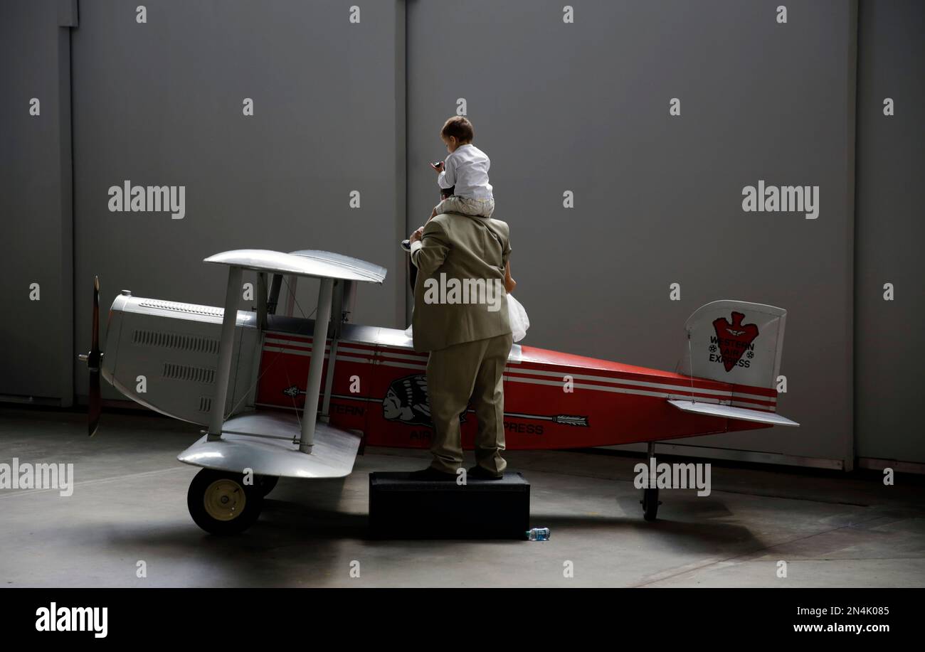 Andy Pharo, 2, sits on the shoulders of his father Mark Pharo, as they ...