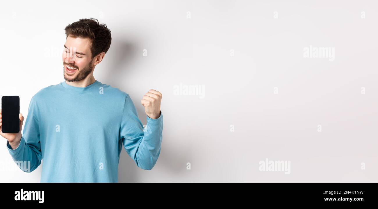 E-commerce and shopping concept. Lucky man winning online, showing ...