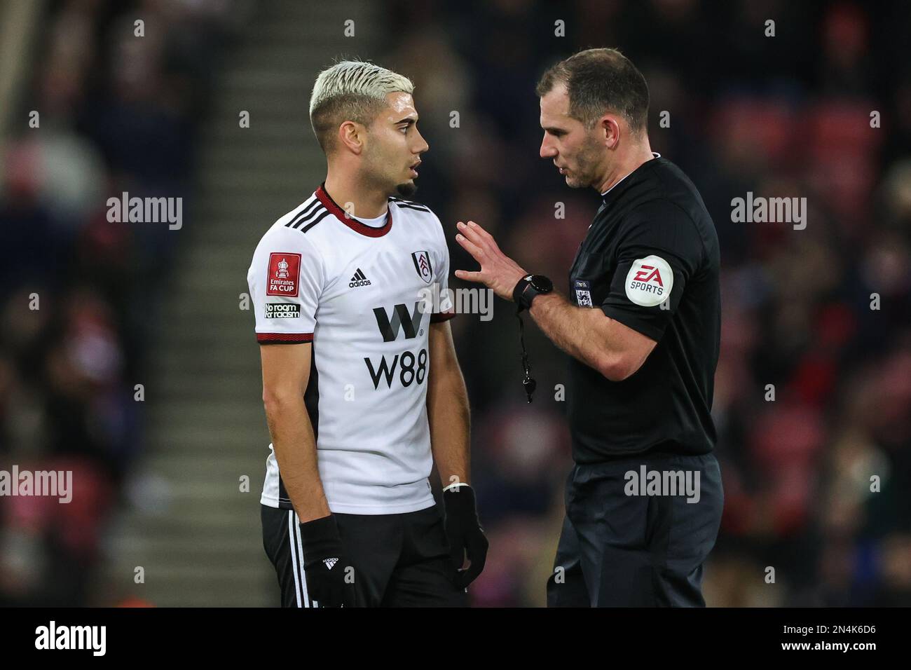 Referee Tim Robinson speaks to Andreas Pereira #18 of Fulham during the ...