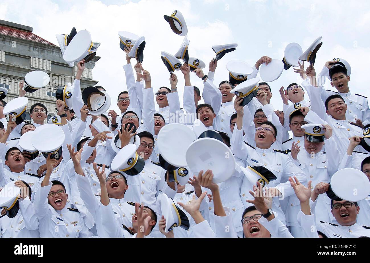 Cadets toss their hats into the aire after graduation during a ceremony ...
