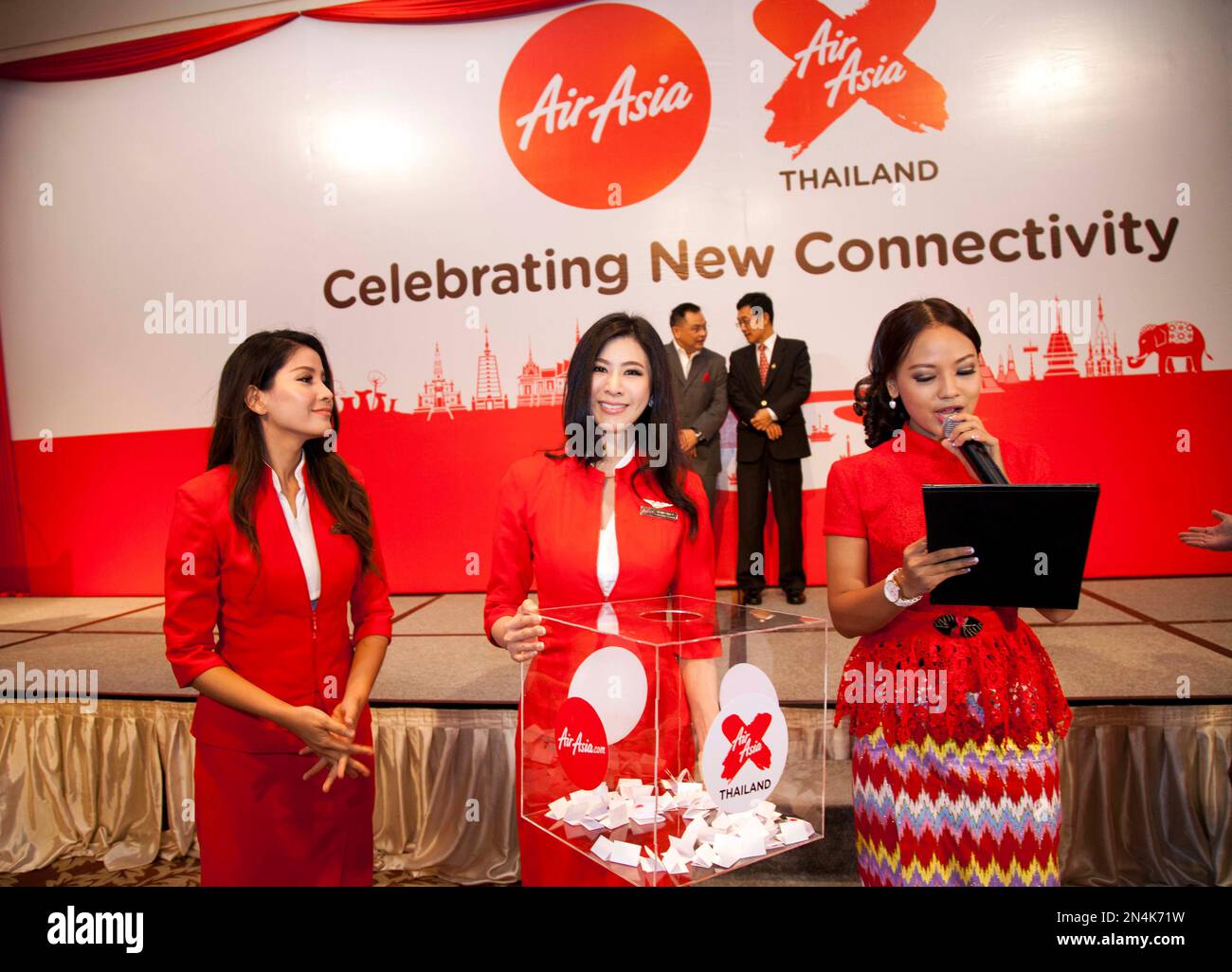 Myanmar model, Nan Khin Zayar, right, announces winners of lucky draw program, accompanied by ...