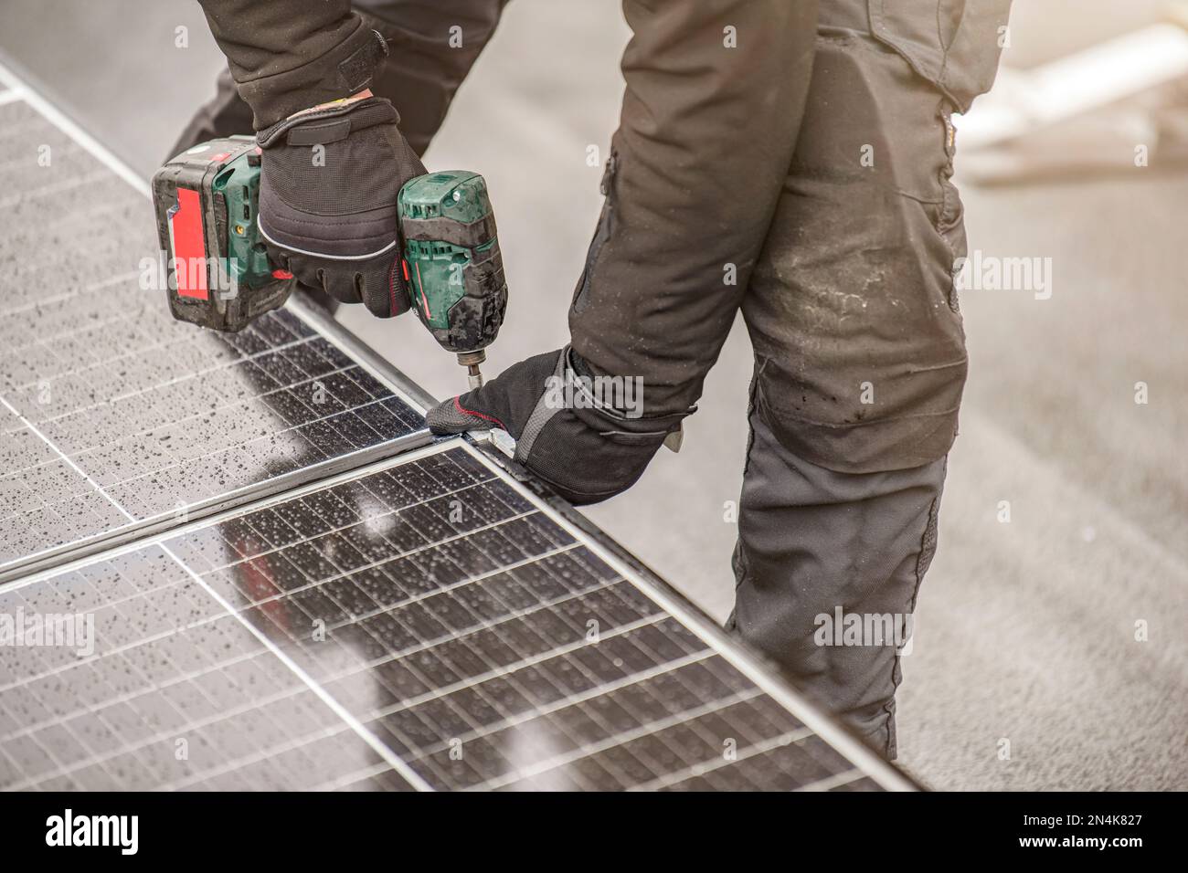 The solar panel installer twists the modules together using aluminum ...